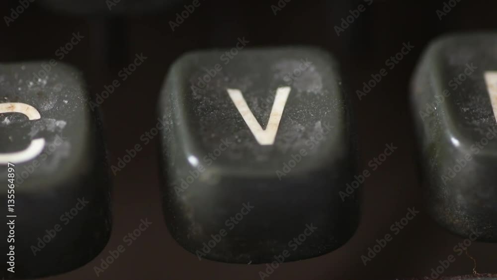 Macro shot on the letter V key typed on an old vintage typewriter ...