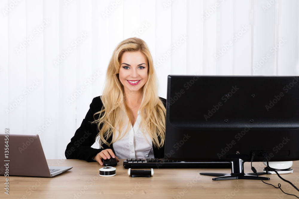 Woman Sitting On Office Desk Stock Photo | Adobe Stock