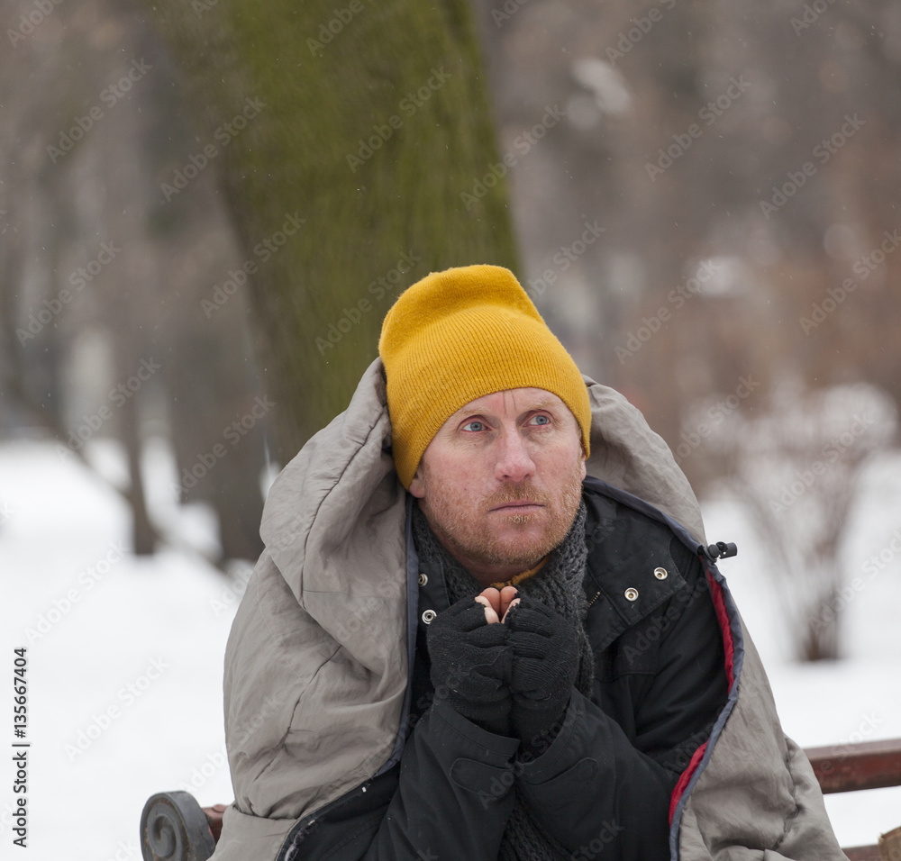 Adult sad homeless man in winter city park Stock Photo | Adobe Stock