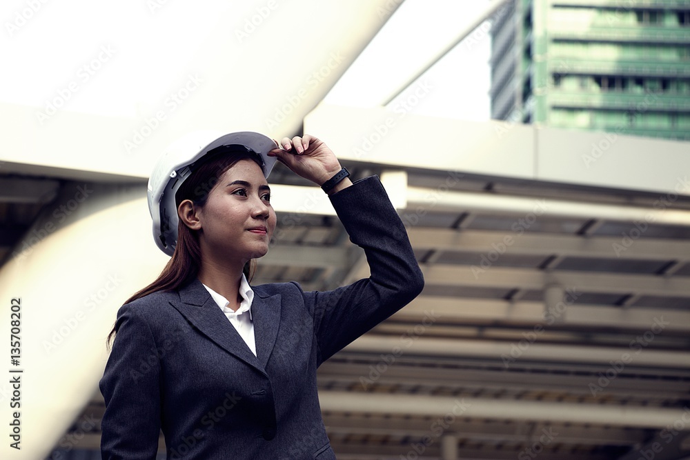 Foto de Woman engineer wears white hard hat at site work.Engineers ...