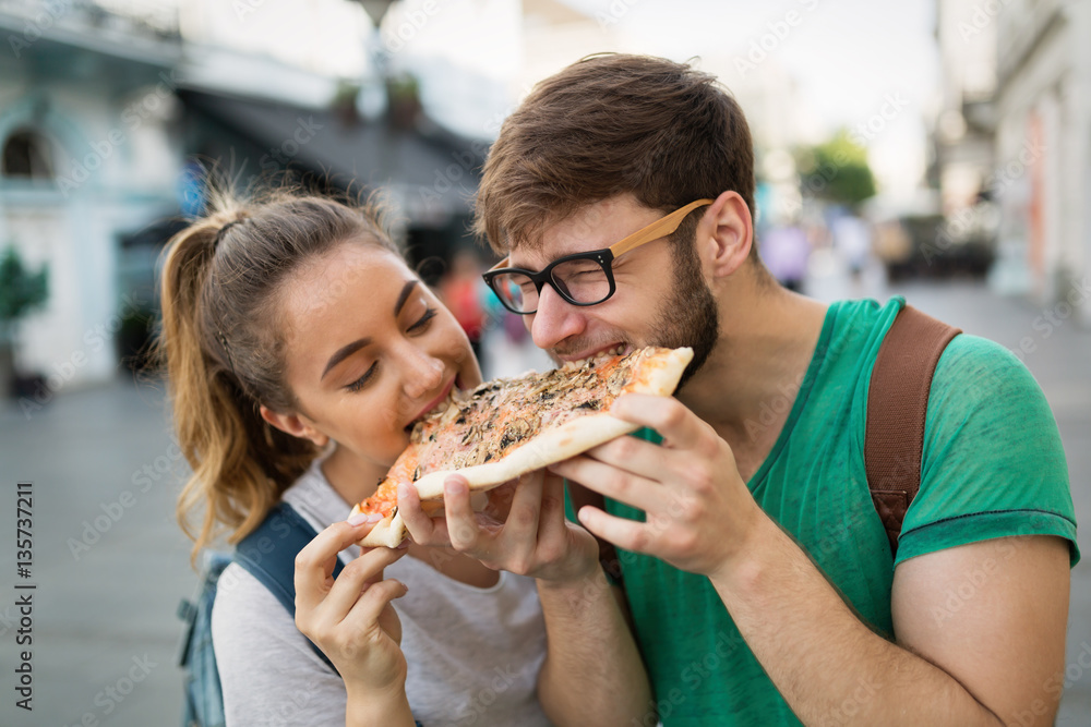 Happy group of people eating pizza outdoors Stock Photo | Adobe Stock