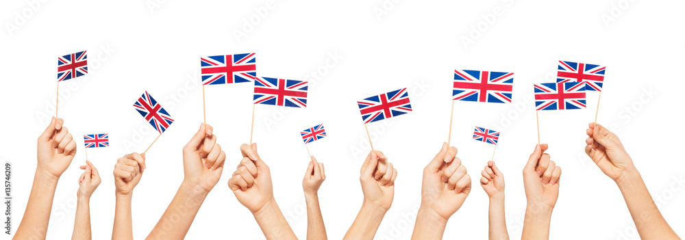 Hands holding and raising flags of Great Britain Stock Photo | Adobe Stock