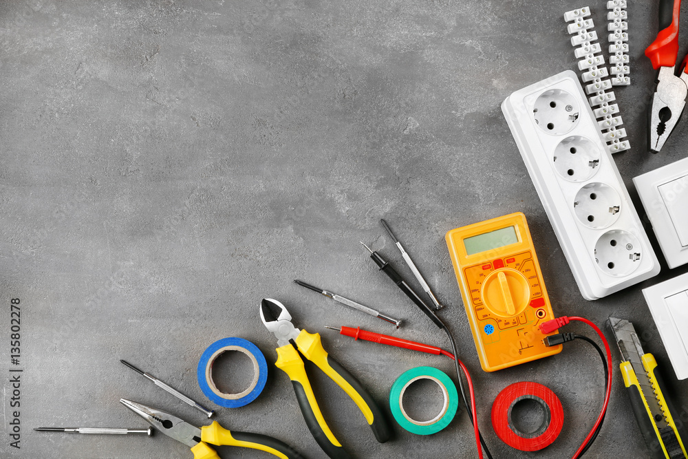 Different electrical tools on grey background Stock Photo | Adobe Stock