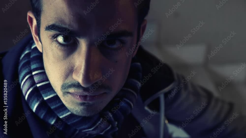 young man in the darkness with sinister look Stock Video | Adobe Stock