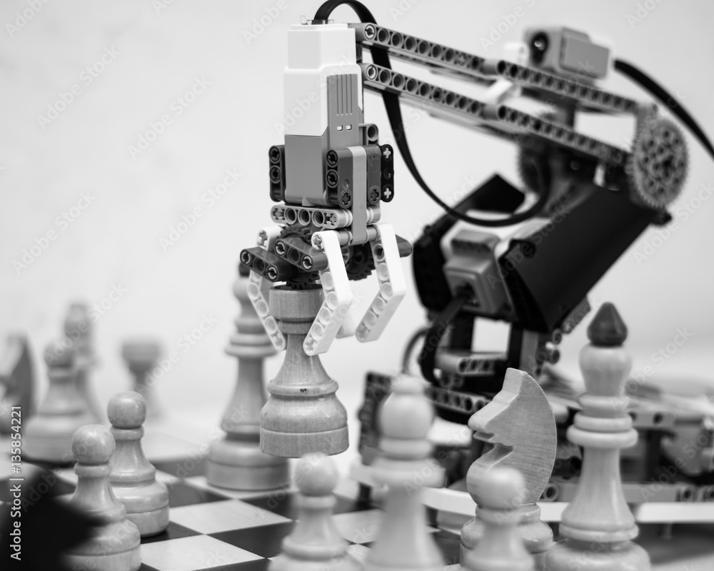 Robot arm play chess with teenager. Concept. STEM education. E-learning ...