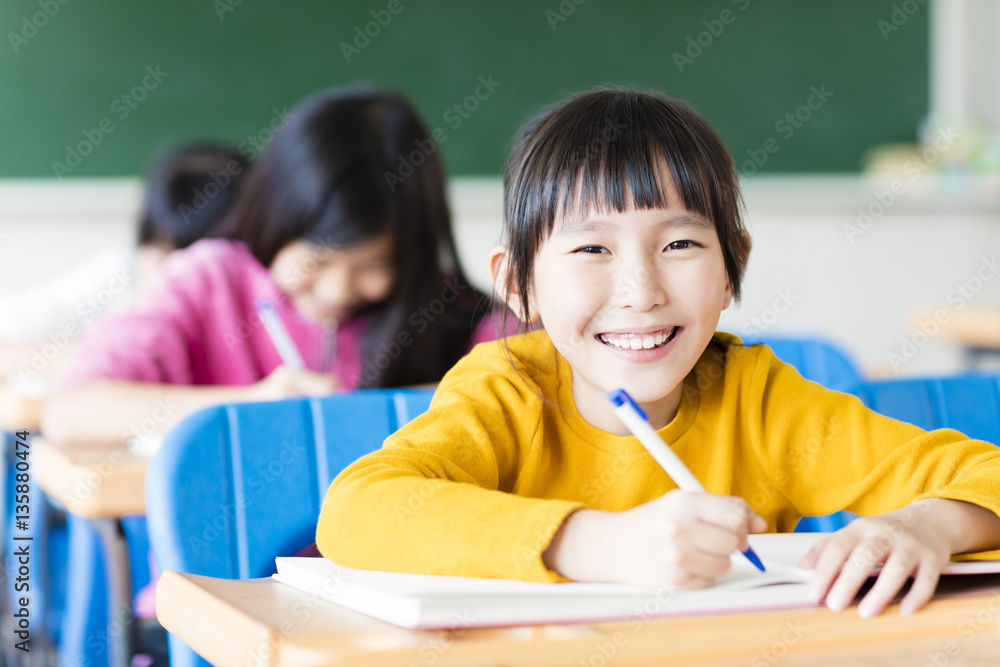 happy little girl student studying in the classroom Stock Photo | Adobe ...