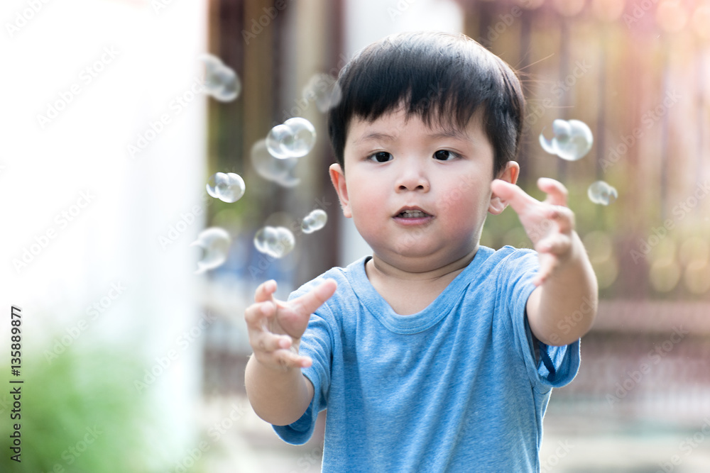 Children playing with bubbles. Stock Photo | Adobe Stock