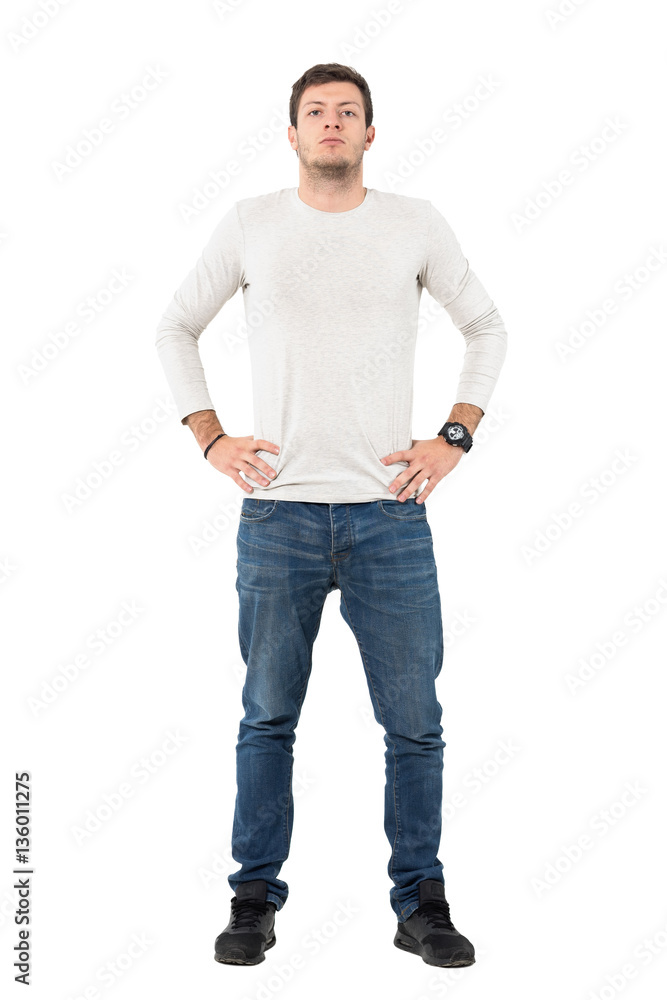 Front view of confident young casual man with arms on hips. Full body ...