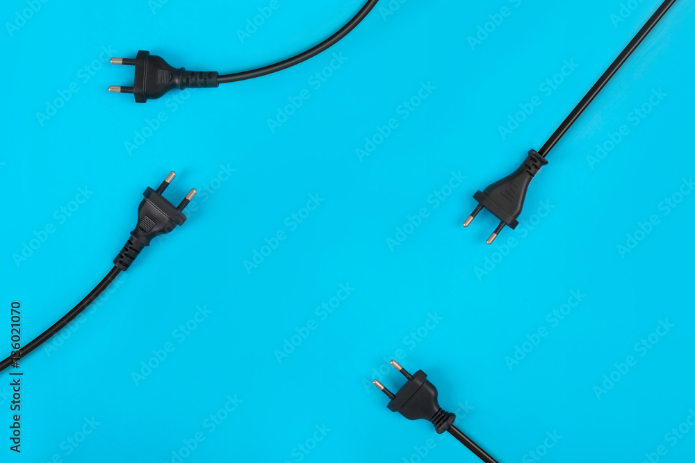 Electrical cords plug and wires unconnected top view on colorful ...