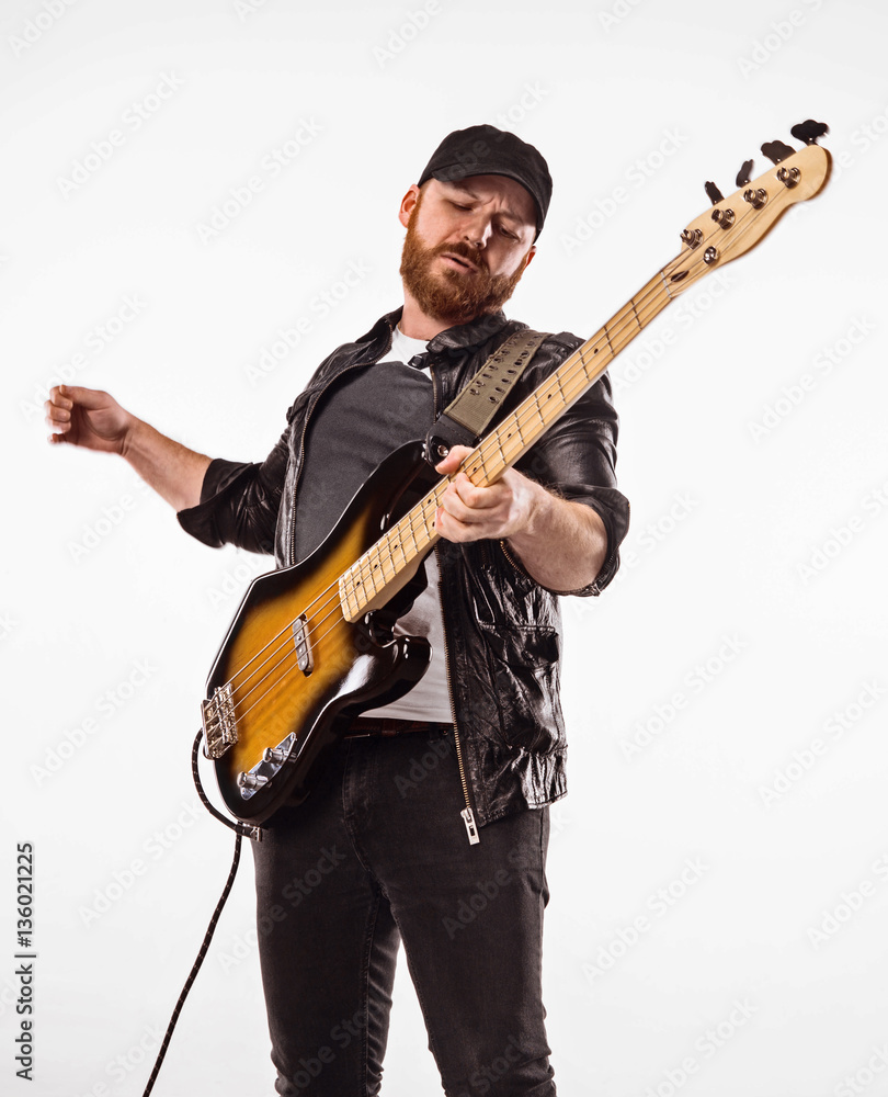 Bassist plays bass guitar. Stock Photo | Adobe Stock