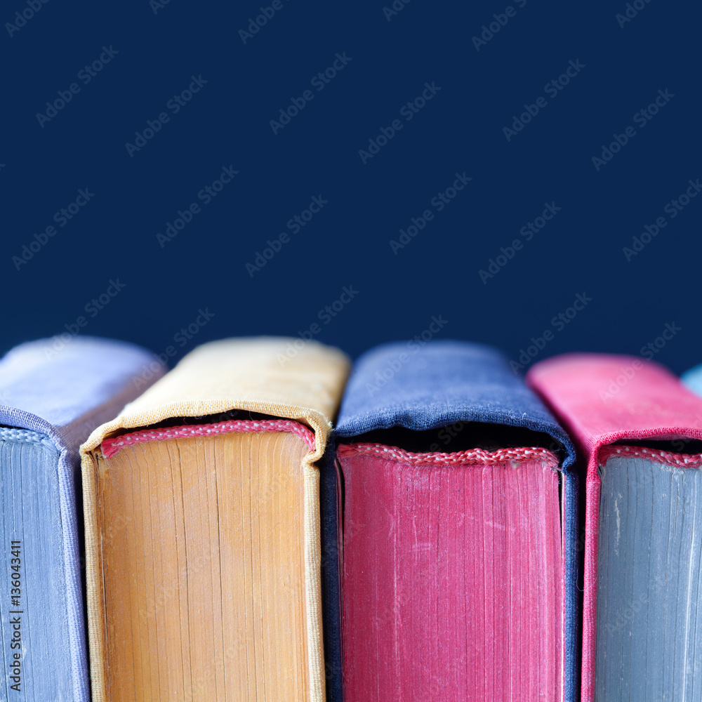 Colorful vintage book covers with colored spines and pages. macro view ...