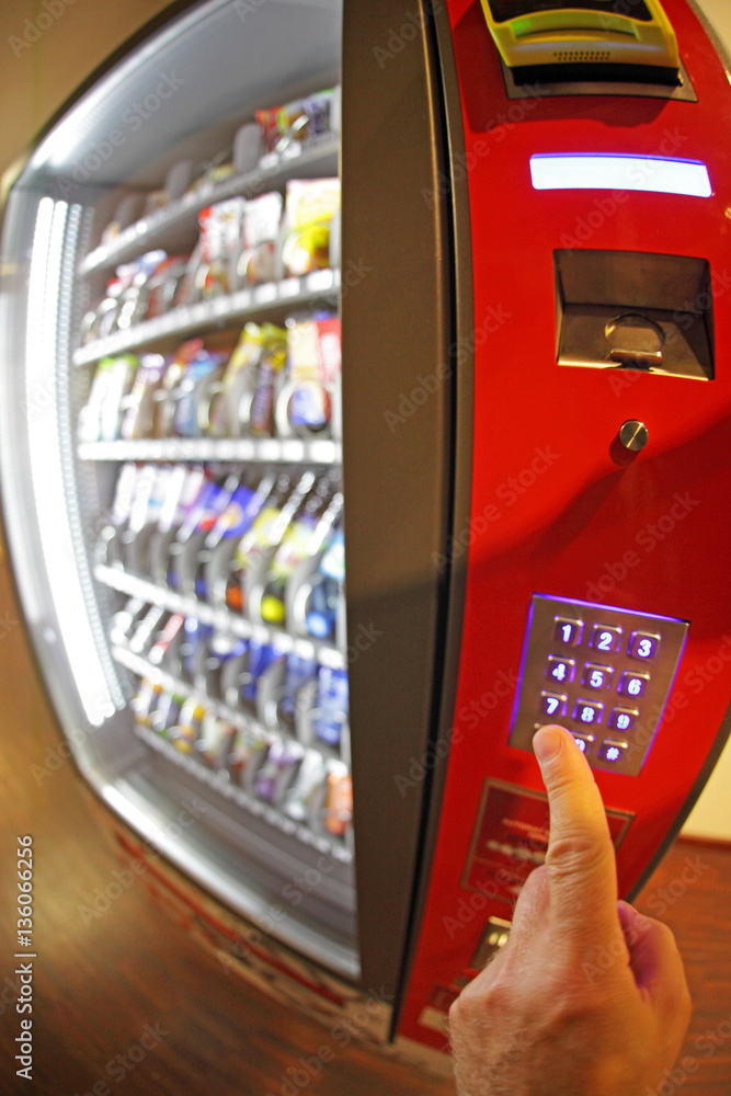 Foto de using a modern vending machine - finger pressing keys at key ...