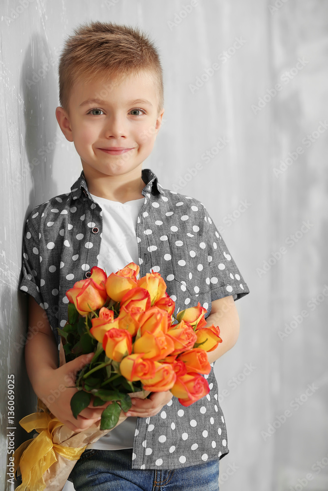 Cute boy with bouquet of beautiful flowers near grunge wall Stock Photo ...