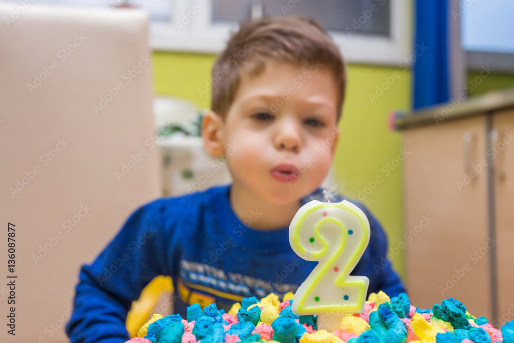 two years old boy blowing candle on birthday cake Stock Photo | Adobe Stock