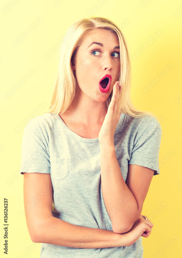 Surprised young woman posing Photos | Adobe Stock