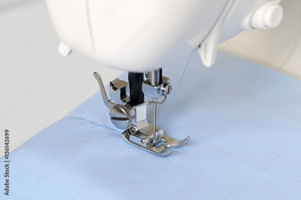 Sewing machine blue fabric, white background Stock Photo | Adobe Stock