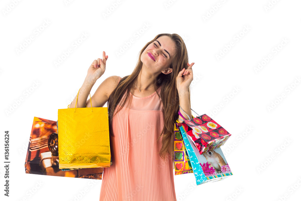 young girl keeps on their hands different color packages from stores ...