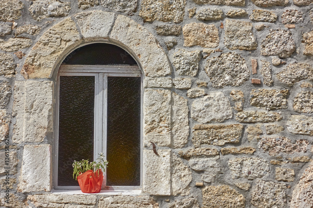arched window on stone wall, Hydra island, Greece. Space for typing ...