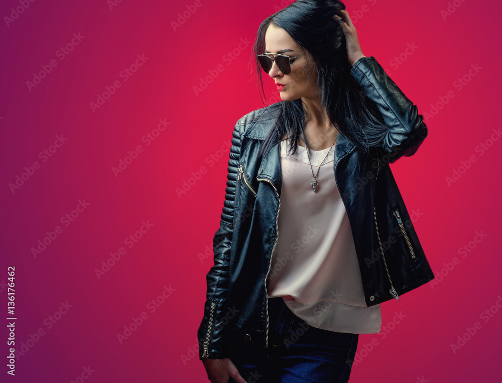 young girl with black hair in a leather jacket and stylish sungl Stock ...
