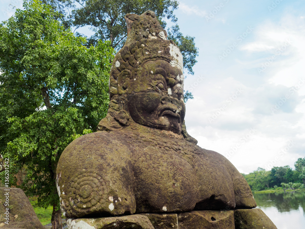 Statue of stone asura or demon at Angkor Thom, ancient capital of Khmer ...
