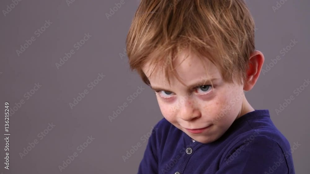 cute little boy trying not to smile or laugh Stock Video | Adobe Stock