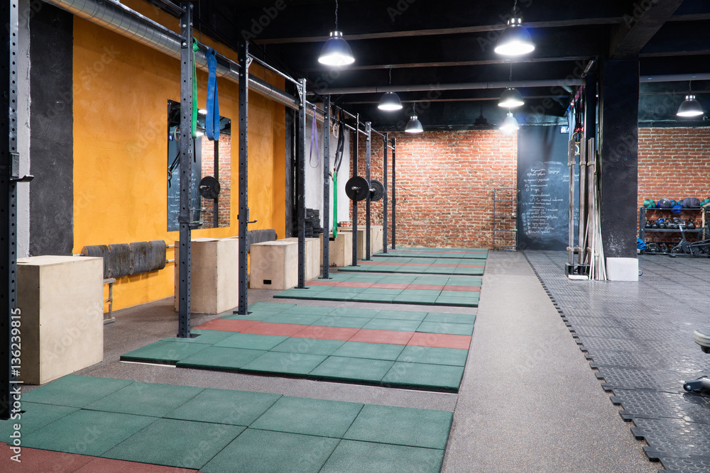 A row of horizontal bars and boxes for exercices in a cross-fit gym ...
