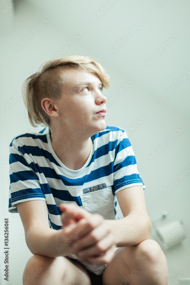 Young blond boy sat on toilet Stock Photo | Adobe Stock