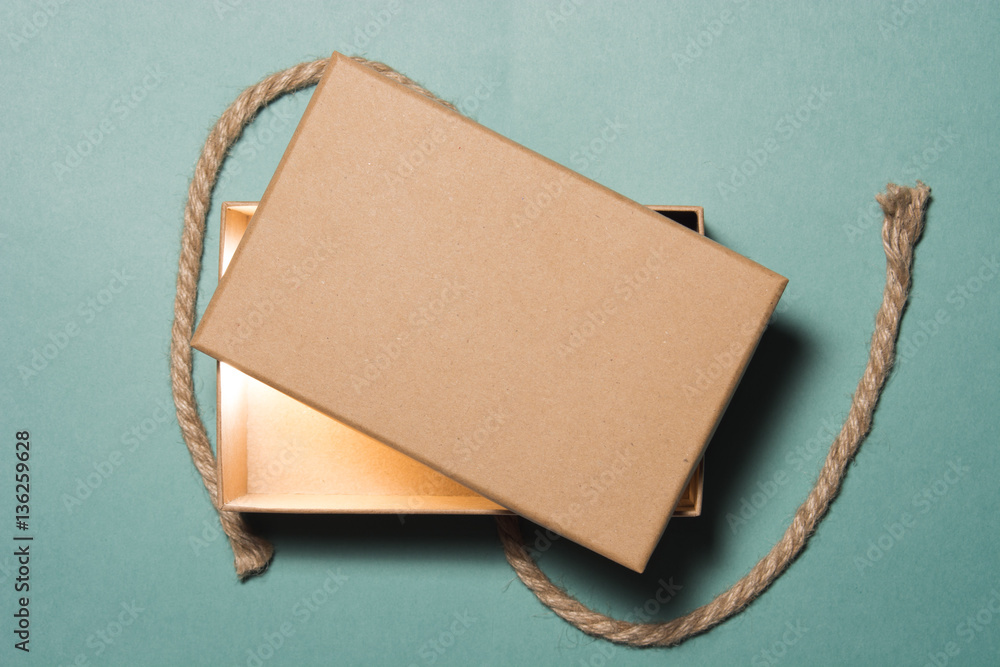 Glowing rustic gift box on table painted green. Gift box packed ...