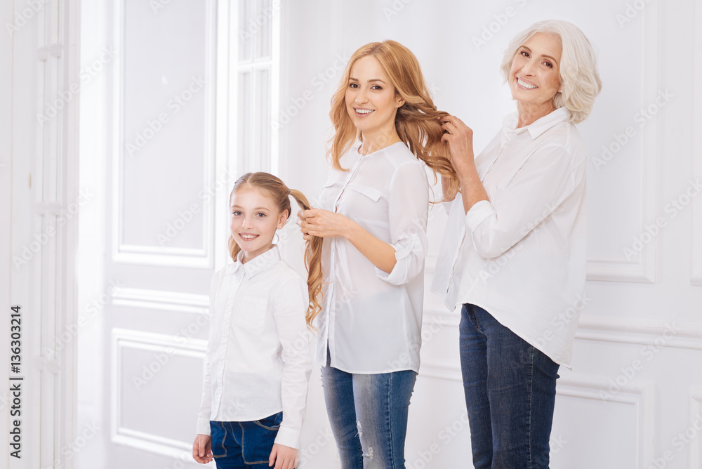 Positive loving family members making hairstyles for each other Stock ...