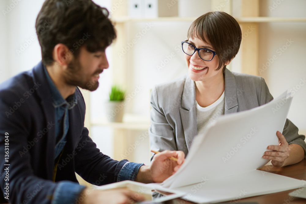 Portrait of two successful business people communicating, making final ...