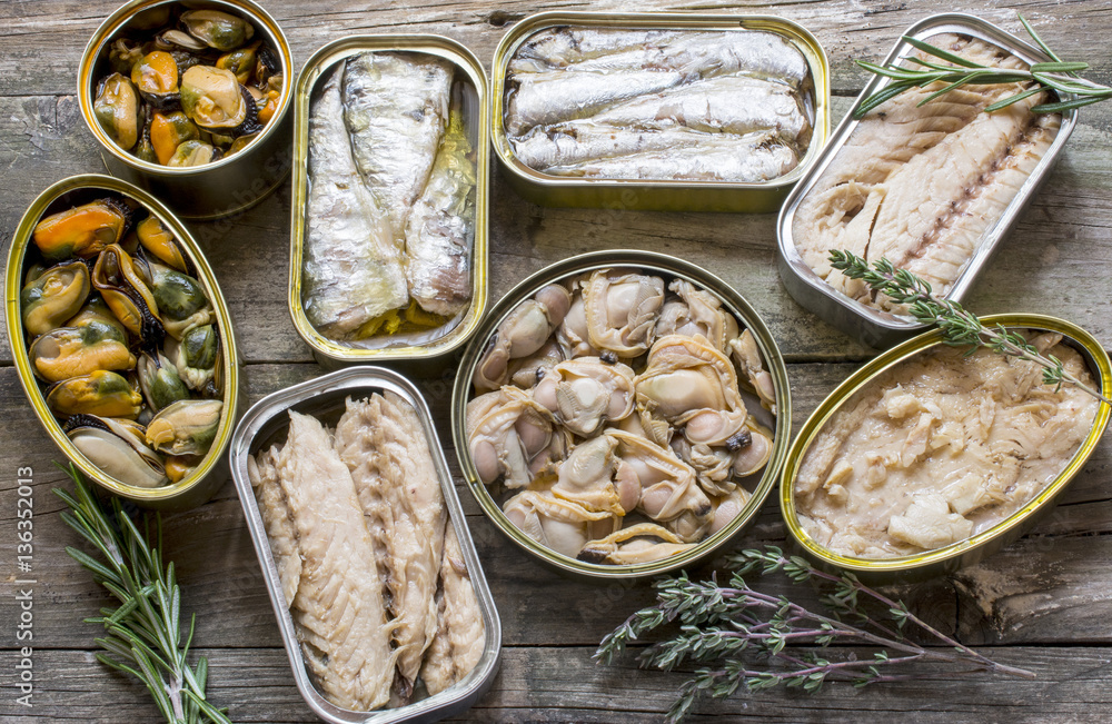 Assortment of cans of canned with different types of fish and seafood ...