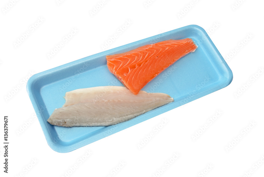 A blue polystyrene tray with a fresh salmon fish fillet and a cod fish ...