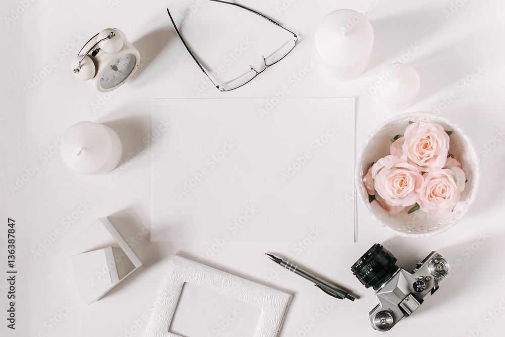 White desk with glasses, roses, candles, pen and film camera. Empty ...