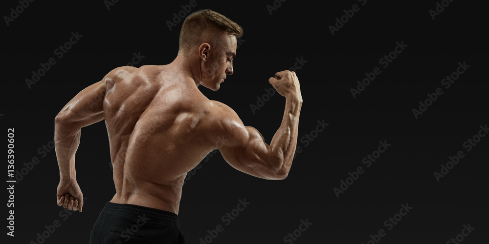 Strong back of a athletic muscular man flexing his arms Stock Photo ...