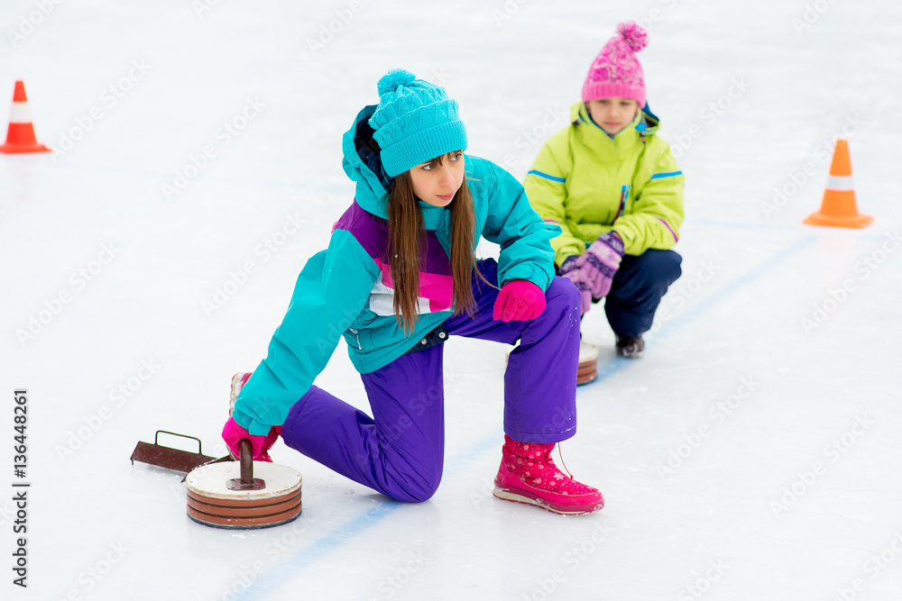 Young girls playing curling Stock Photo | Adobe Stock