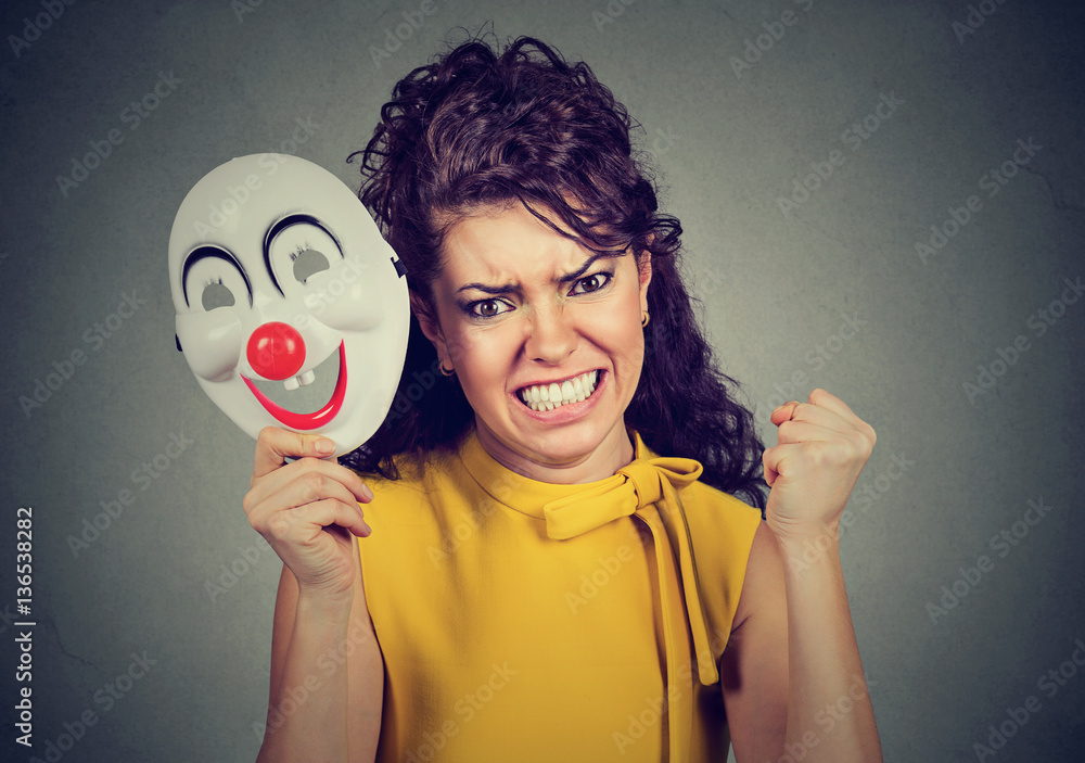 Angry screaming woman taking off clown mask expressing happiness Stock ...