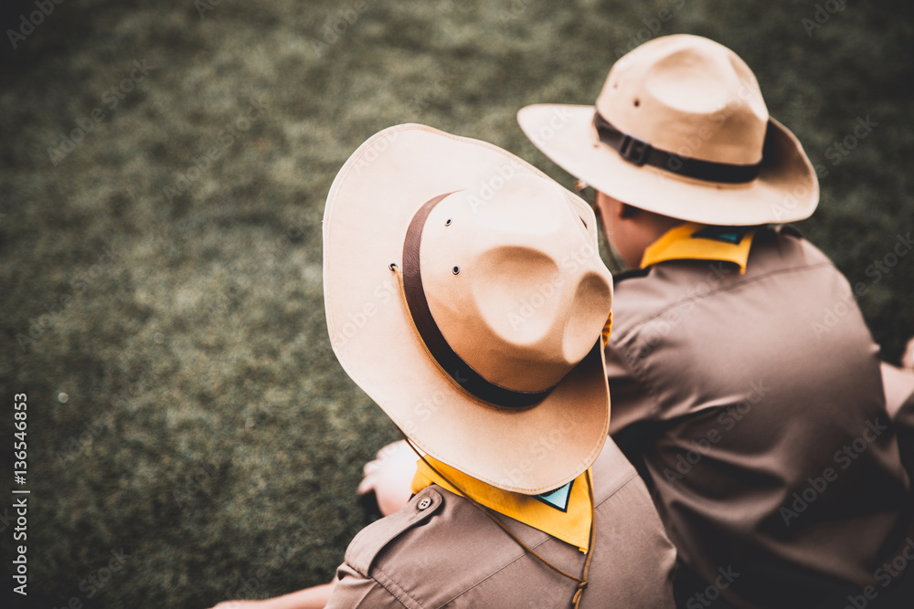 Foto de Rear view or backside of two asian boy scout sitting on ...