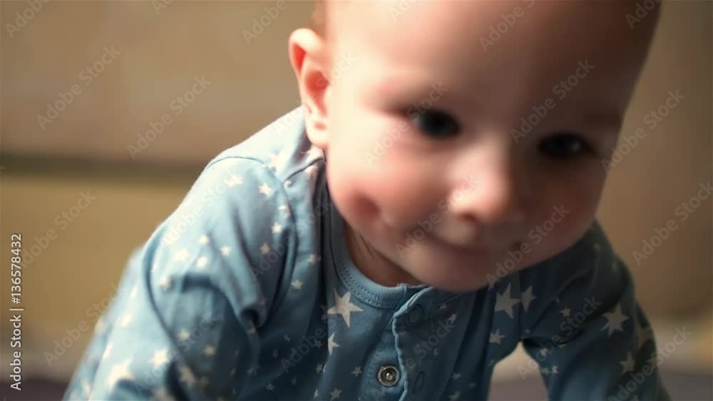 cute smiling baby boy with dimples on cheeks and in star pyjamas ...