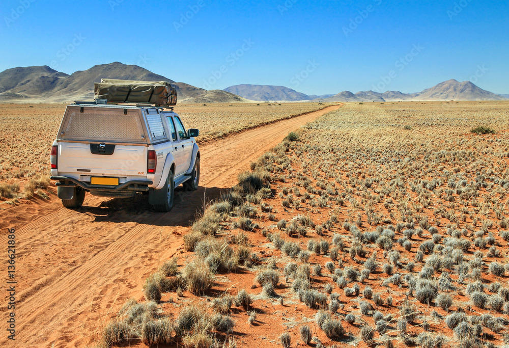 Pickup truck driving on desert road towards the Tiras mountains Stock ...
