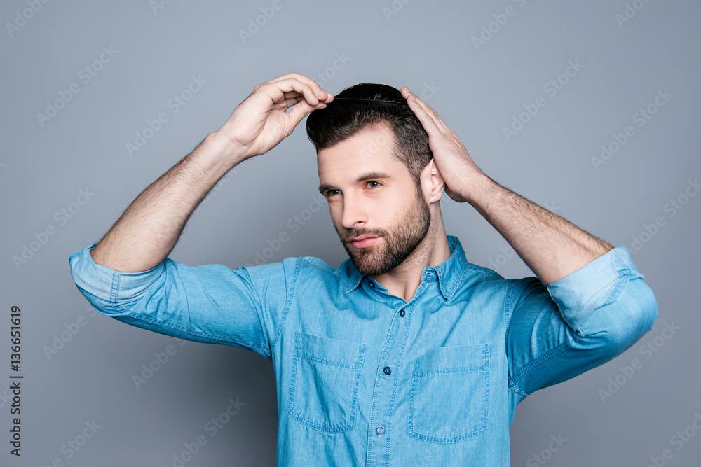 Portrait of handsome young guy combing his hair with fingers Stock ...