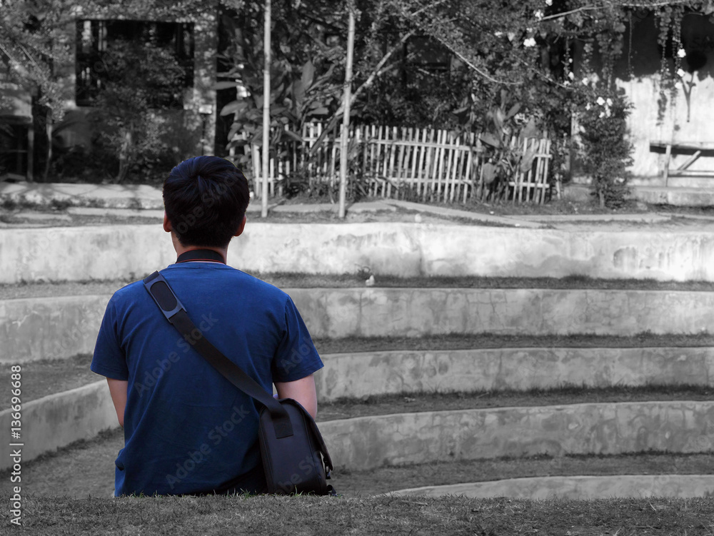 Man sitting alone with black and white background Stock Photo | Adobe Stock