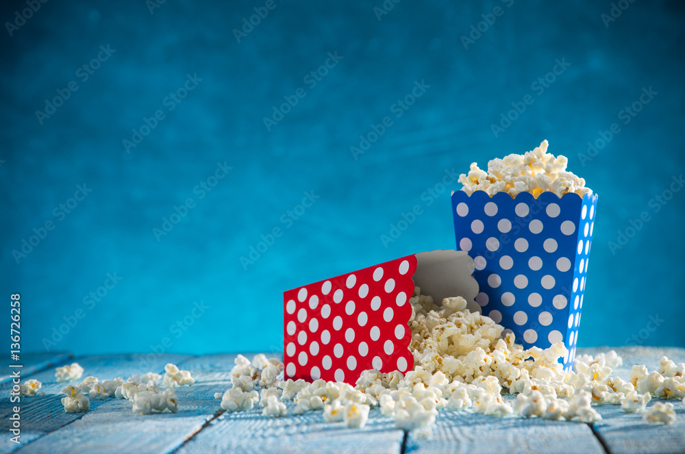Boxes of popcorn on blue background. Stock Photo | Adobe Stock