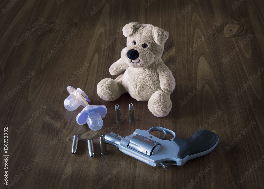 Generic teddy bear, pacifiers and gun Stock Photo | Adobe Stock