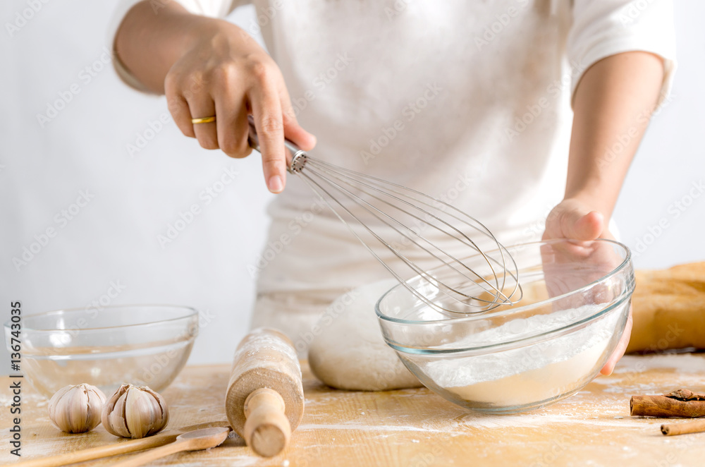 Close up shot hands of woman holding stainless steel whisk and b Stock ...