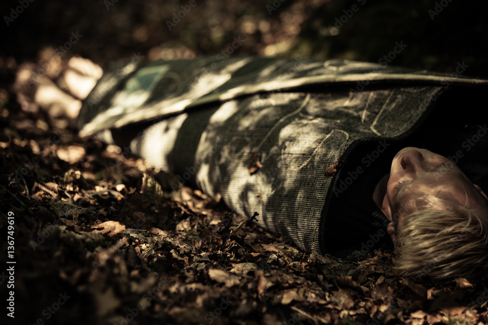 Dead body of a teenage boy lying in a forest Stock Photo | Adobe Stock