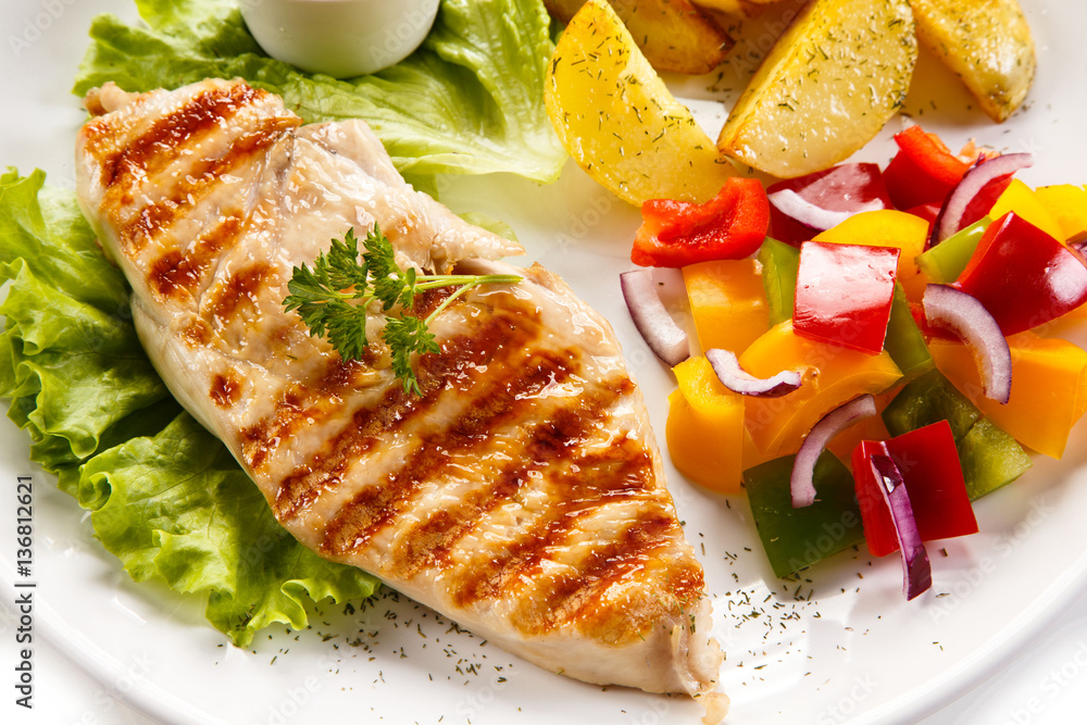 Grilled chicken fillet, chips and vegetable salad Stock Photo | Adobe Stock