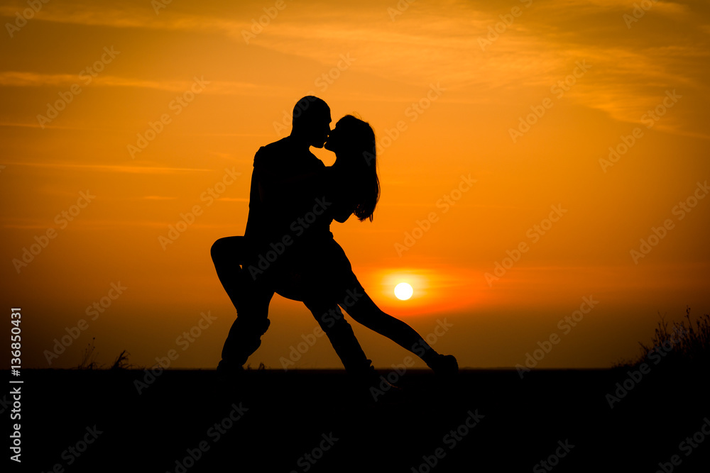 silhouette teenager lovers couple with sun between on sunset dusk sky ...