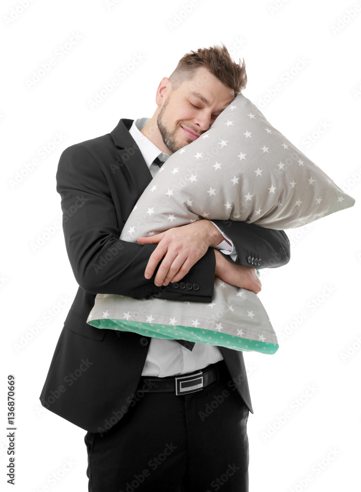 Young business man hugging pillow and continuing to sleep, isolated on ...