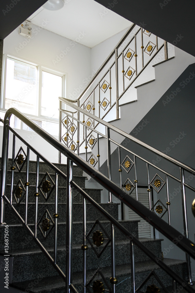 Stainless steel railing inside a building. Stock Photo | Adobe Stock