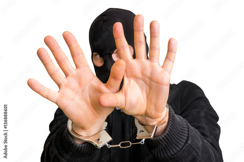 Masked thief in handcuffs isolated on white background Stock Photo ...